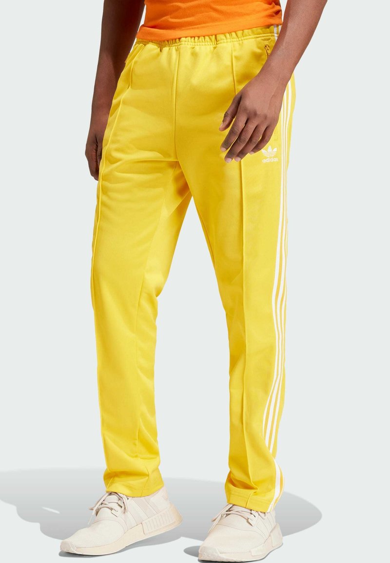 adidas Originals CLASSIC - Tracksuit bottoms - bold gold/gold-coloured ...