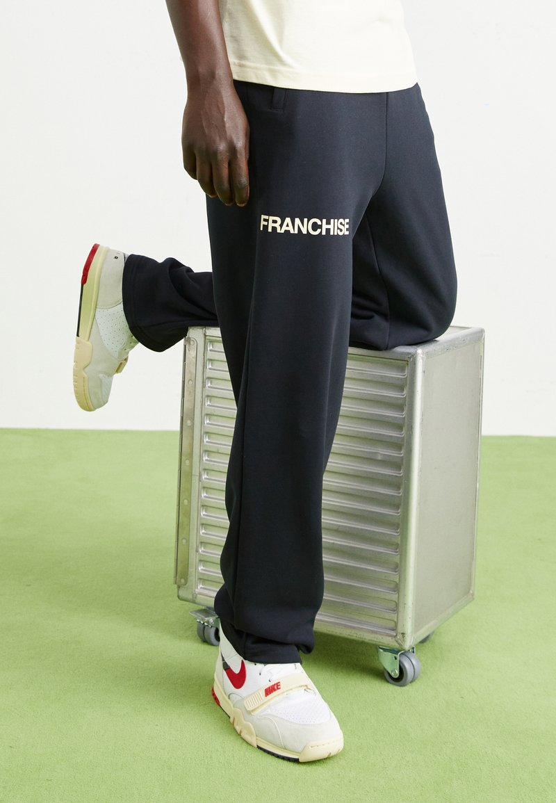 Franchise LOGO PANTS - Tracksuit bottoms - black - Zalando.ie