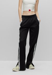 HUGO NELEGA - Pantalon de survêtement - black one/noir - ZALANDO.FR