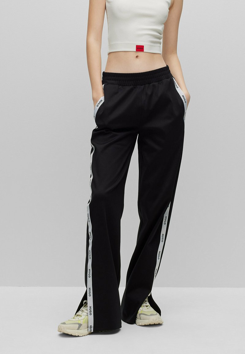 HUGO NELEGA - Pantalon de survêtement - black one/noir - ZALANDO.FR