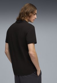 Puma ASTON MARTIN ARAMCO F1® TEAM JACQUARD - Piké - black/svart ...