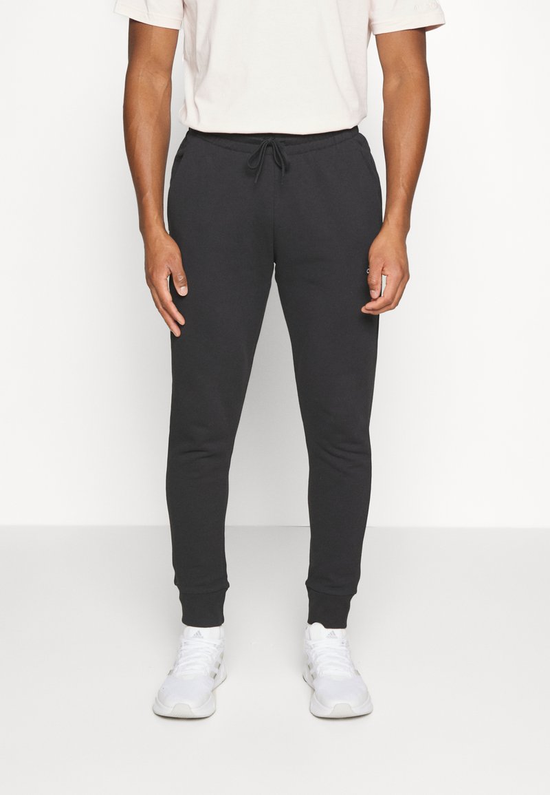 adidas Sportswear ESSENTIALS - Tracksuit bottoms - black - Zalando.co.uk