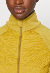 Athleta FLURRY FORCE INSULATED JACKET - Laufjacke - palo verde green ...