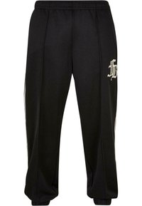 FUBU OLD ENGLISH - Tracksuit bottoms - black - Zalando.co.uk