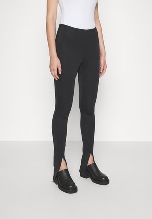 Calvin Klein Jeans SPLIT HEM SLIM MILANO PANTS - Stoffhose - black ...