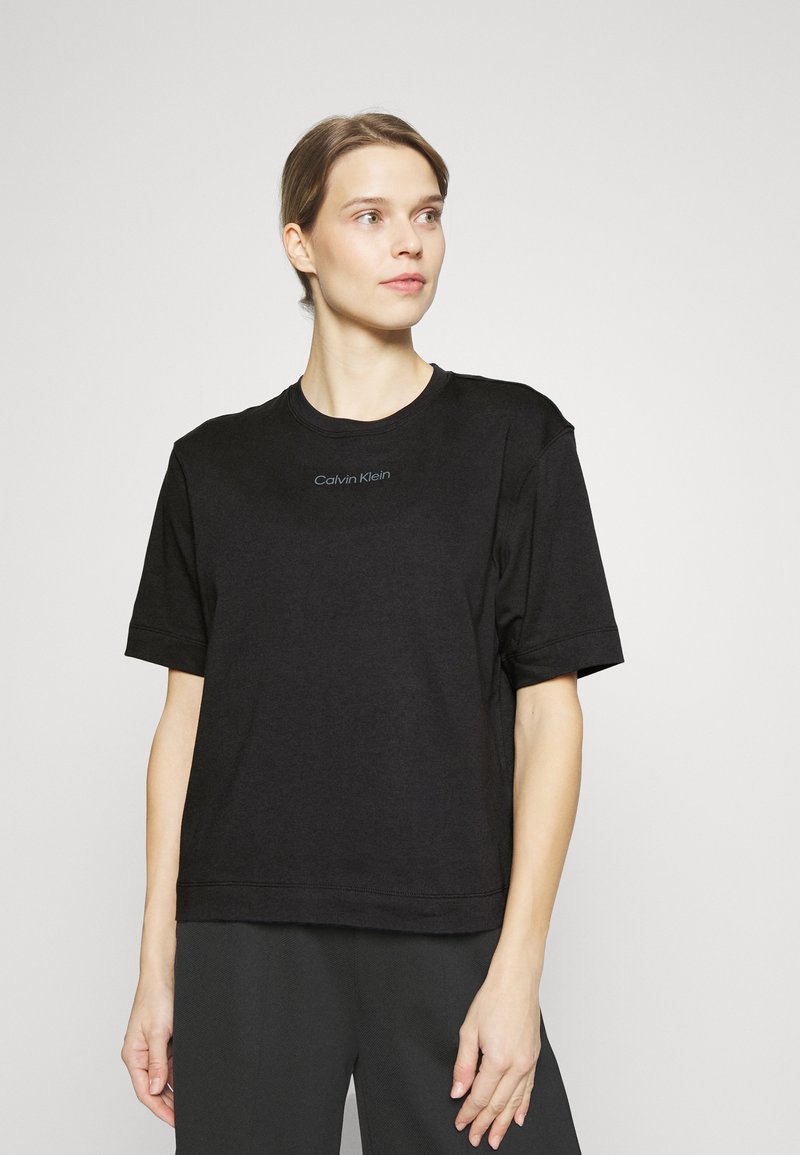 Calvin Klein Performance RELAXED - Sports T-shirt - black beauty/gold ...