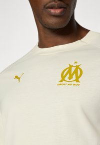 Puma OM PUMATECH POCKET TEE - Sports T-shirt - alpine snow/golden ...