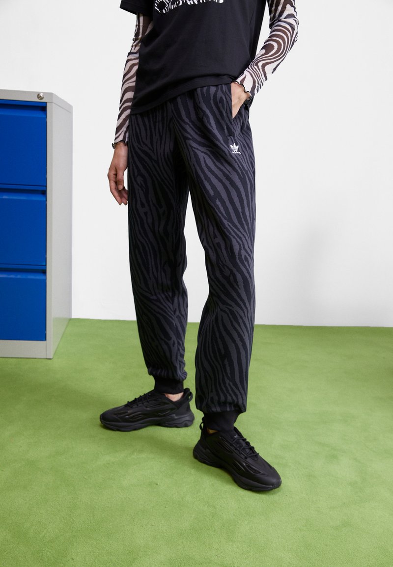 adidas Originals ALLOVER ZEBRA - Tracksuit bottoms - carbon/black/black ...