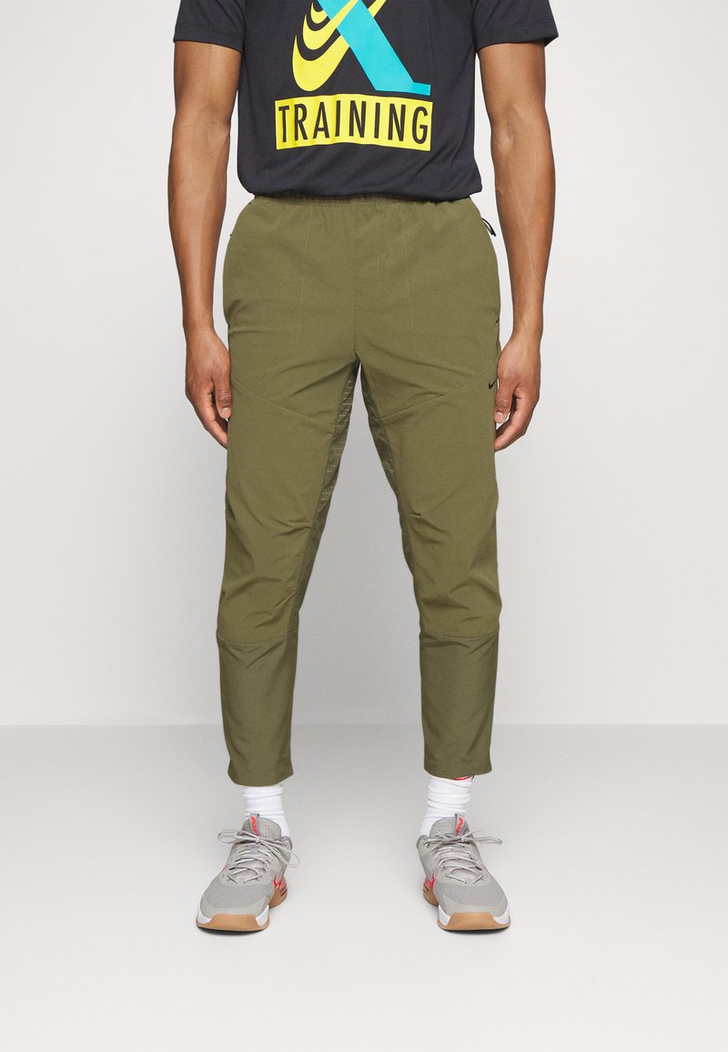 Nike Performance AXIS PANT - Tracksuit bottoms - medium olive/black ...