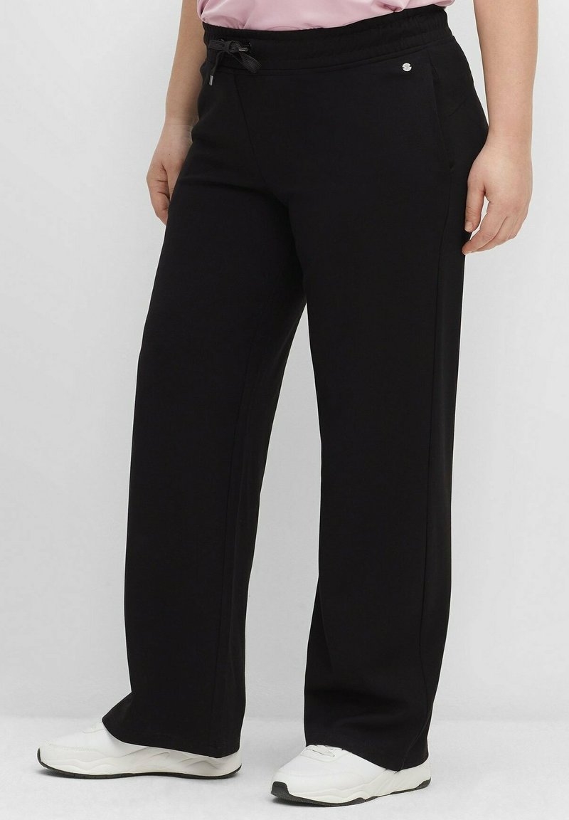 Sheego - Spodnie treningowe/czarny - Zalando.pl