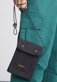 Carhartt WIP HASTE NECK POUCH UNISEX - Across body bag - black - Zalando.ie