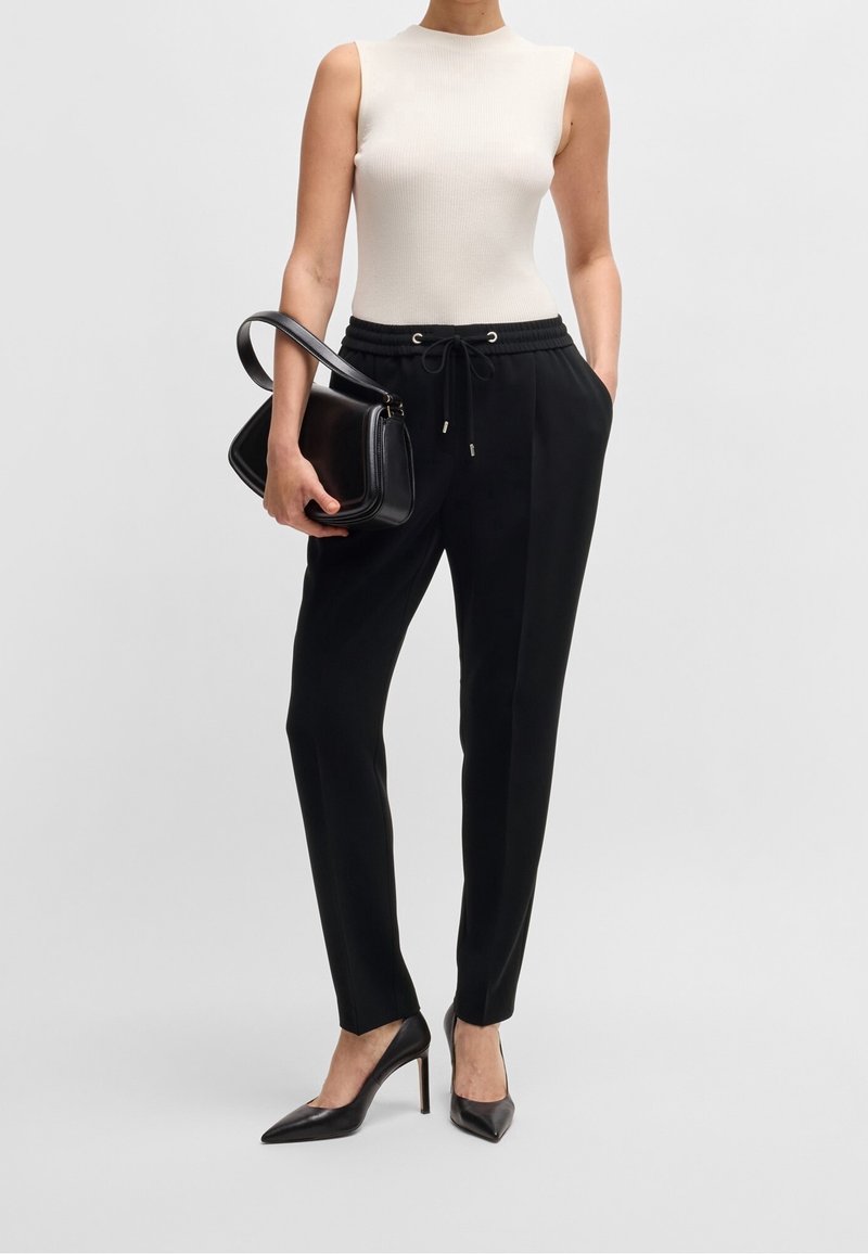 BOSS Trousers - black - (Pre-owned) - Zalando