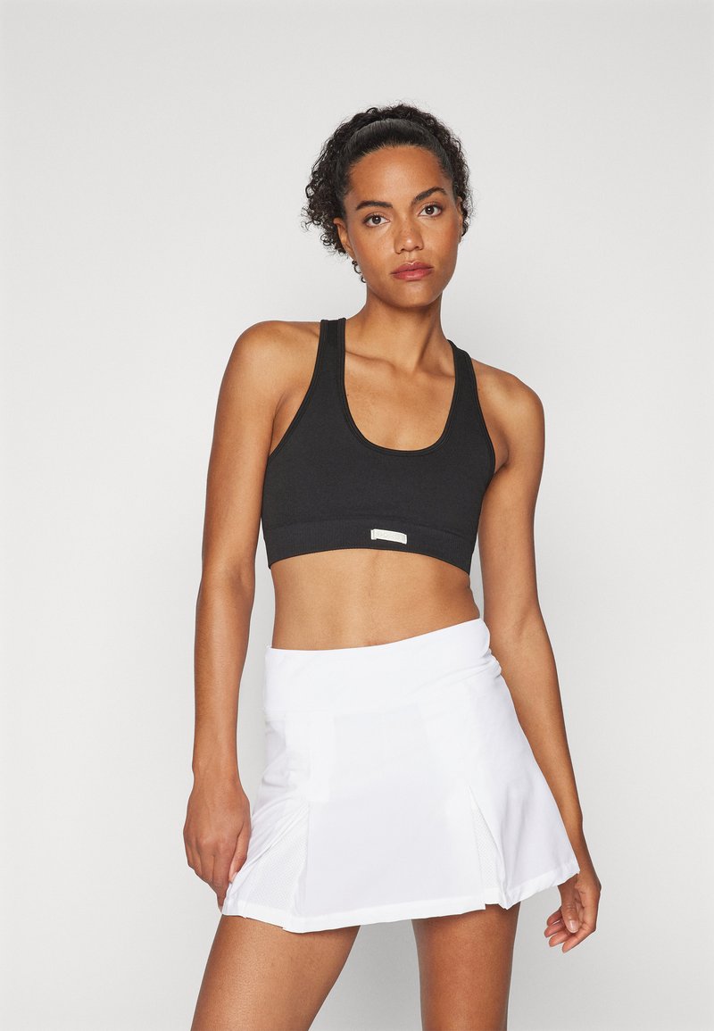 Björn Borg STUDIO LOW SEAMLESS BRA - Light support sports bra - black ...