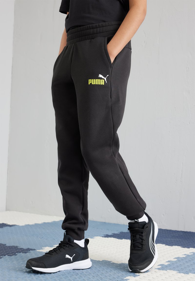 Puma LOGO PANTS UNISEX - Pantalon de survêtement - black/lime sheen/noir - ZALANDO.FR