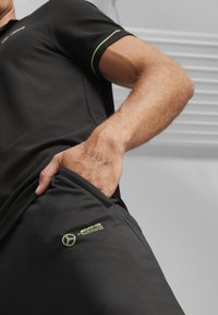 Puma AMG PETRONAS MOTORSPORT CLOUDSPUN - Tracksuit bottoms - black ...