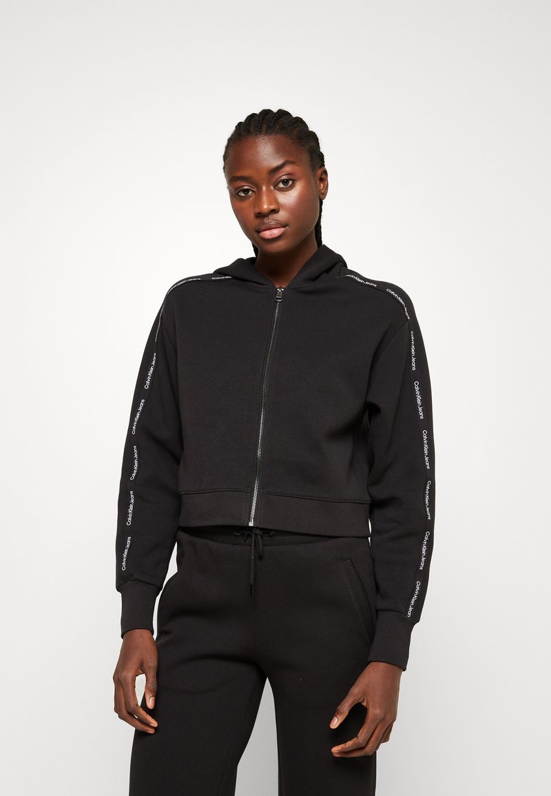 Calvin Klein Jeans SLEEVES LOGO PIPING ZIP-THROUGH - Sweatjacke - black ...