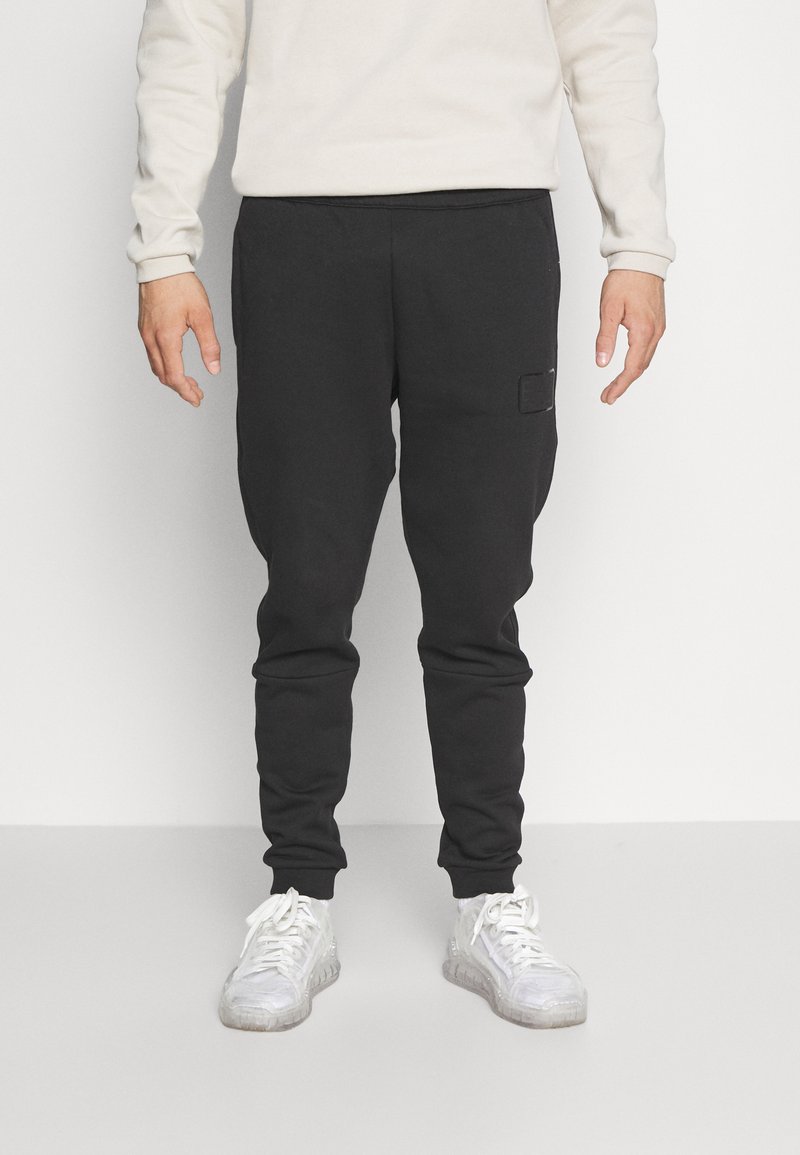 EA7 Emporio Armani TROUSERS - Pantalon de survêtement - black/noir - ZALANDO.CH