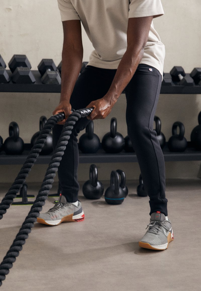 Champion ICONS CUFF PANTS FITTED LEG - Tracksuit bottoms - black ...