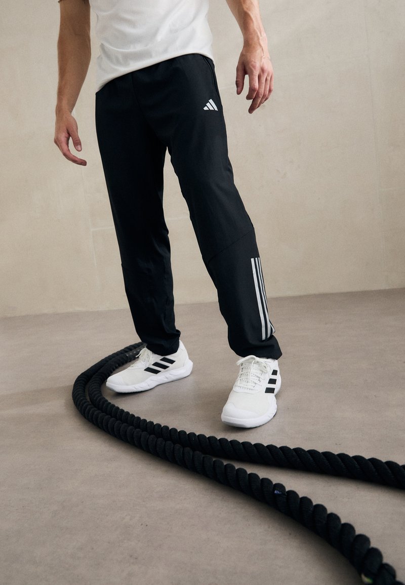 adidas Performance GYM 3 STRIPES - Tracksuit bottoms - black - Zalando.ie