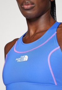 The North Face HAKUUN BRA - Medium support sports bra - solar blue/blue ...