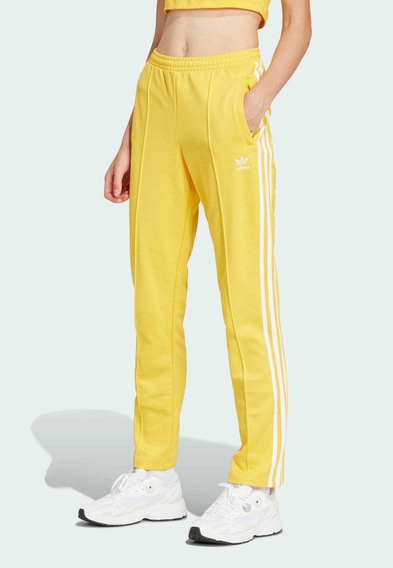 adidas Originals MONTREAL - Tracksuit bottoms - bold gold/gold-coloured ...