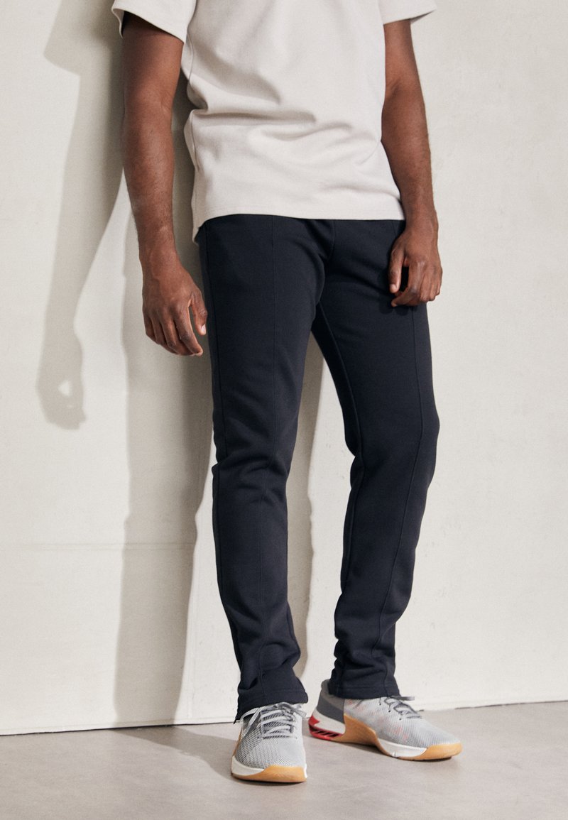 Champion ICONS WIDE LEG PANTS - Jogginghose - black/schwarz - Zalando.ch