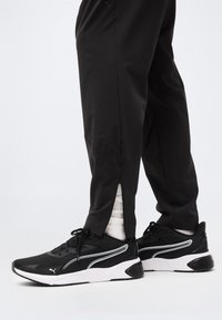 Puma WARM UP - Tracksuit bottoms - black - Zalando