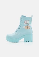 Koi Footwear FLYING PUSHEEN SKY BOOTS - Platform ankle boots - blue ...