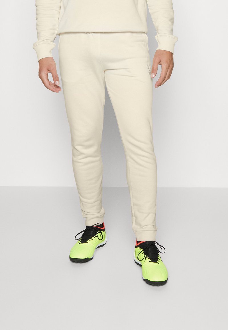 KLABU LOGO PANTS - Jogginghose - off white/camo/offwhite - Zalando.ch