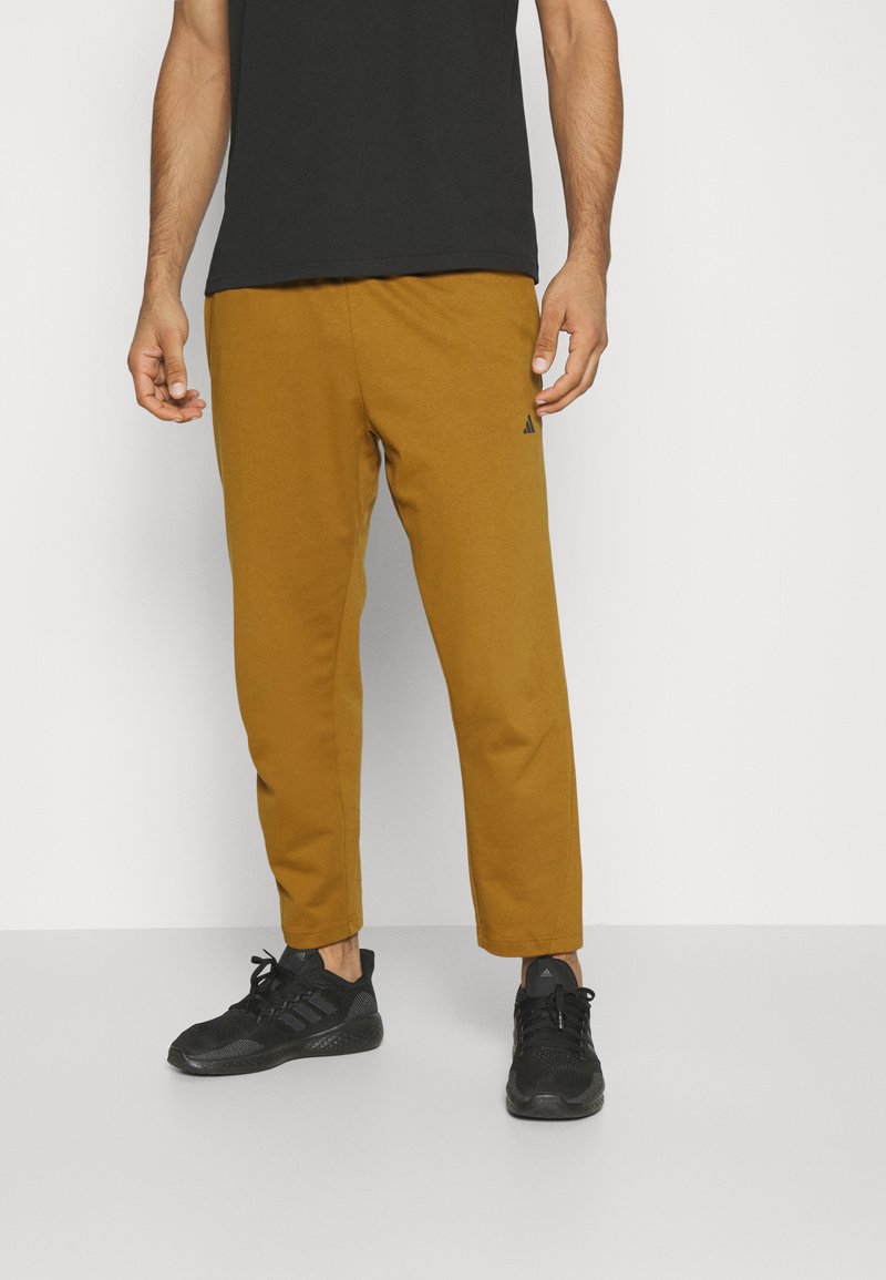adidas Performance YOGA BASE PANT - Tracksuit bottoms - bronze strata ...