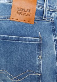 Replay ANBASS HYPERFLEX RE-USED XLITE - Straight leg jeans - light blue ...