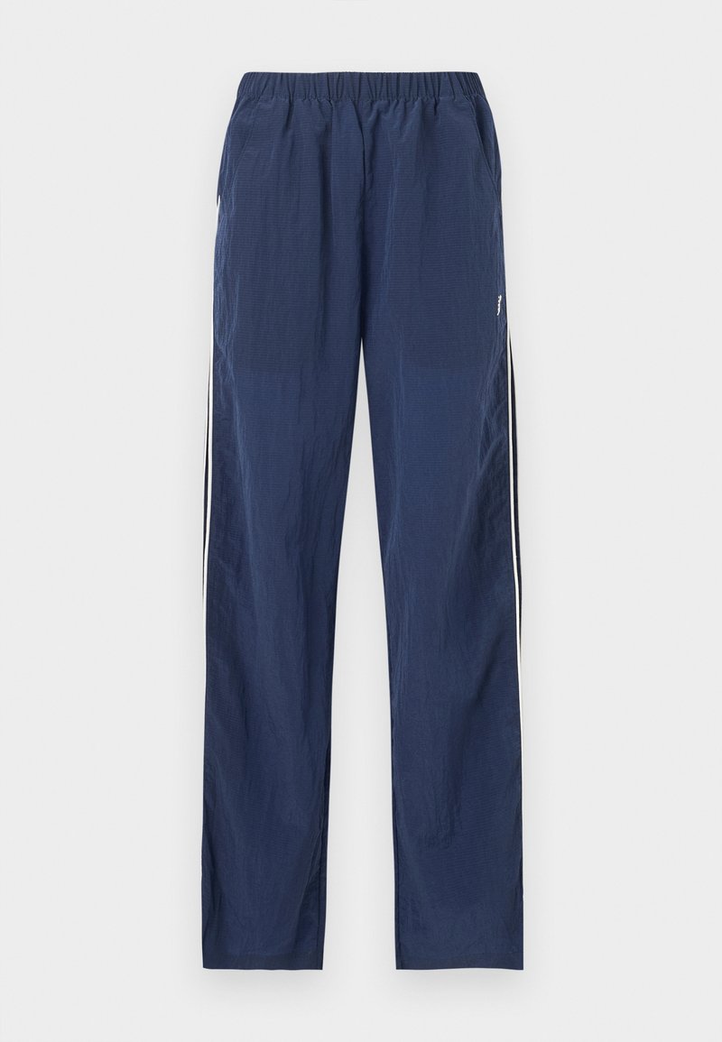 New Balance SPORT LEGACY - Tracksuit bottoms - navy/dark blue - Zalando
