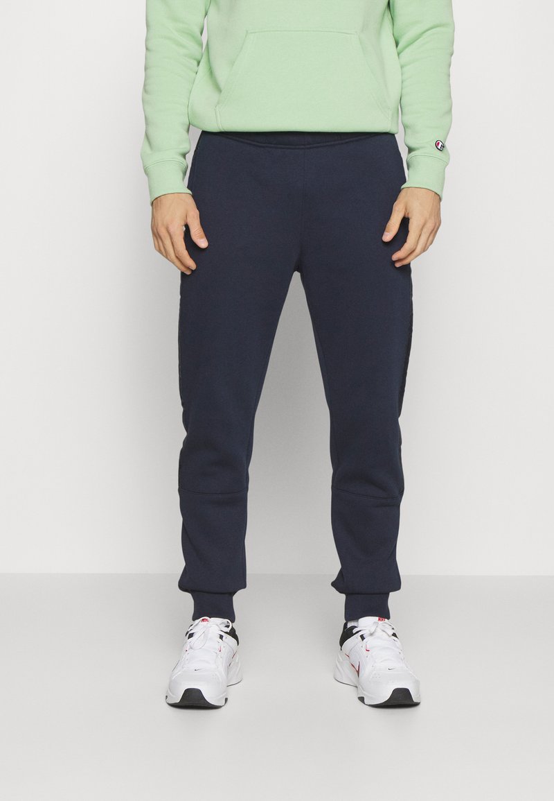 Champion TAPE CUFF PANTS - Tracksuit bottoms - darkblue/dark blue ...