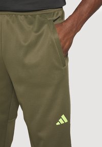 adidas Performance PANT - Tracksuit bottoms - olive strata/pulse lime ...