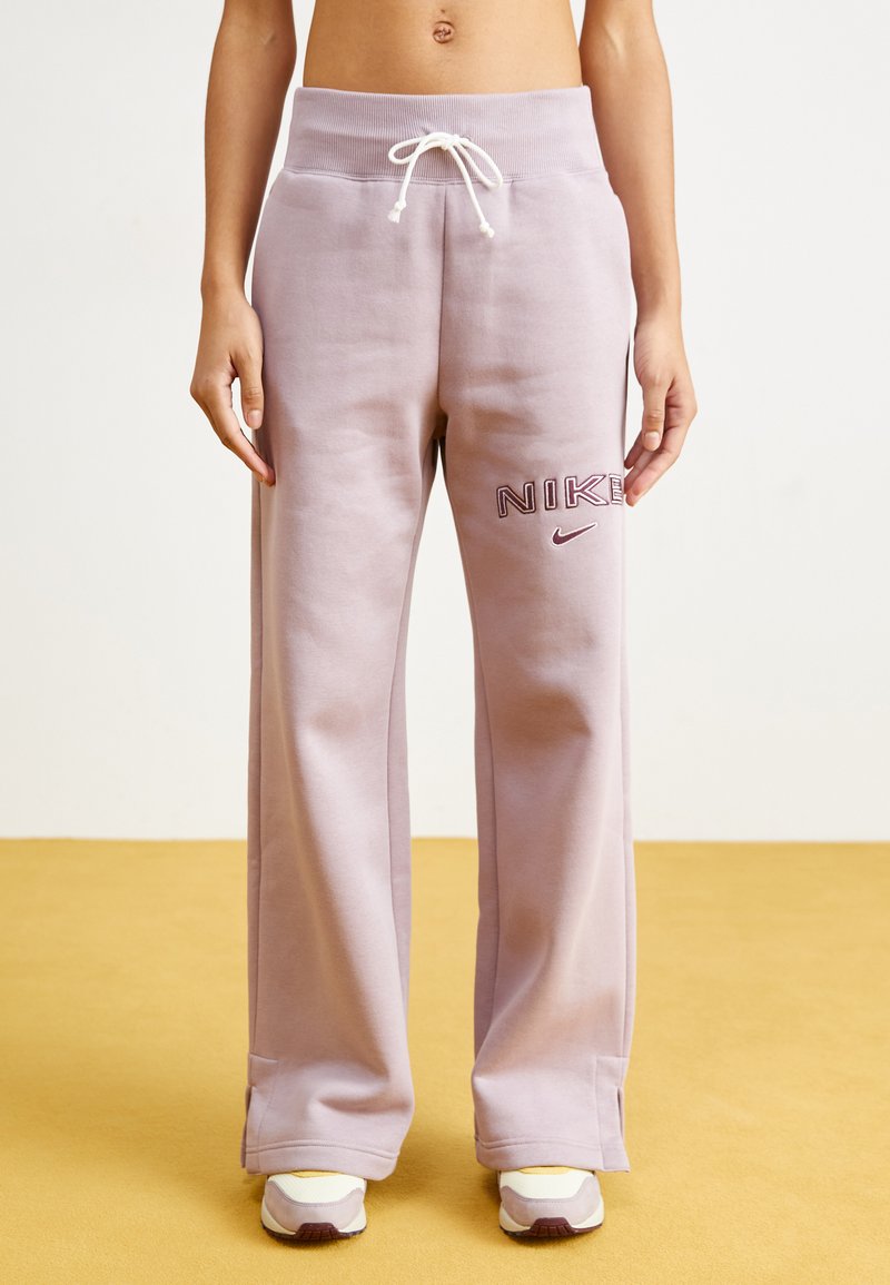 Nike Sportswear LOGO - Tracksuit bottoms - light violet ore/purple ...