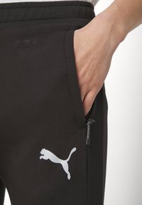 Puma EVOSTRIPE - Pantalon de survêtement - black/noir - ZALANDO.FR