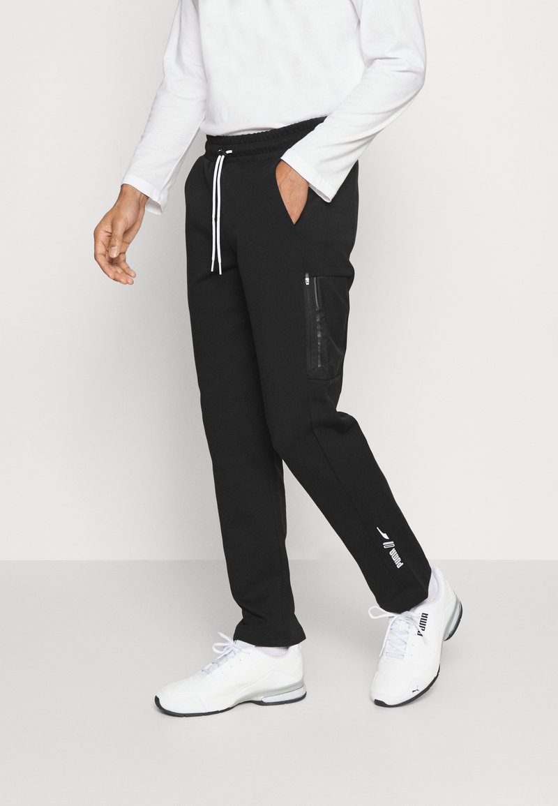 Puma RAD/CAL CARGO PANTS - Tracksuit bottoms - black - Zalando