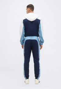 Lacoste Sport Tracksuit bottoms - navy blue/aral/white/dark blue - Zalando