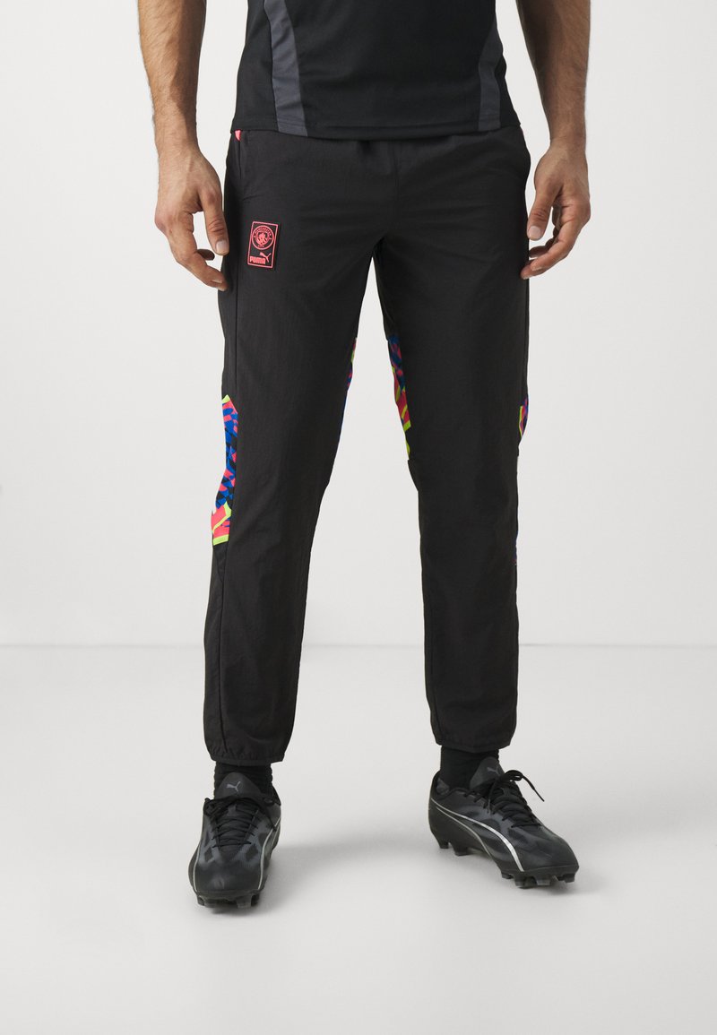 Puma MANCHESTER CITY FTBLNRGY PANTS - Club wear - black/sunset glow ...