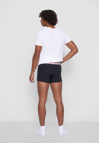 Levi's® MEN PLACED LOGO BOXER BRIEF 4 PACK - Lange Boxershorts - black ...