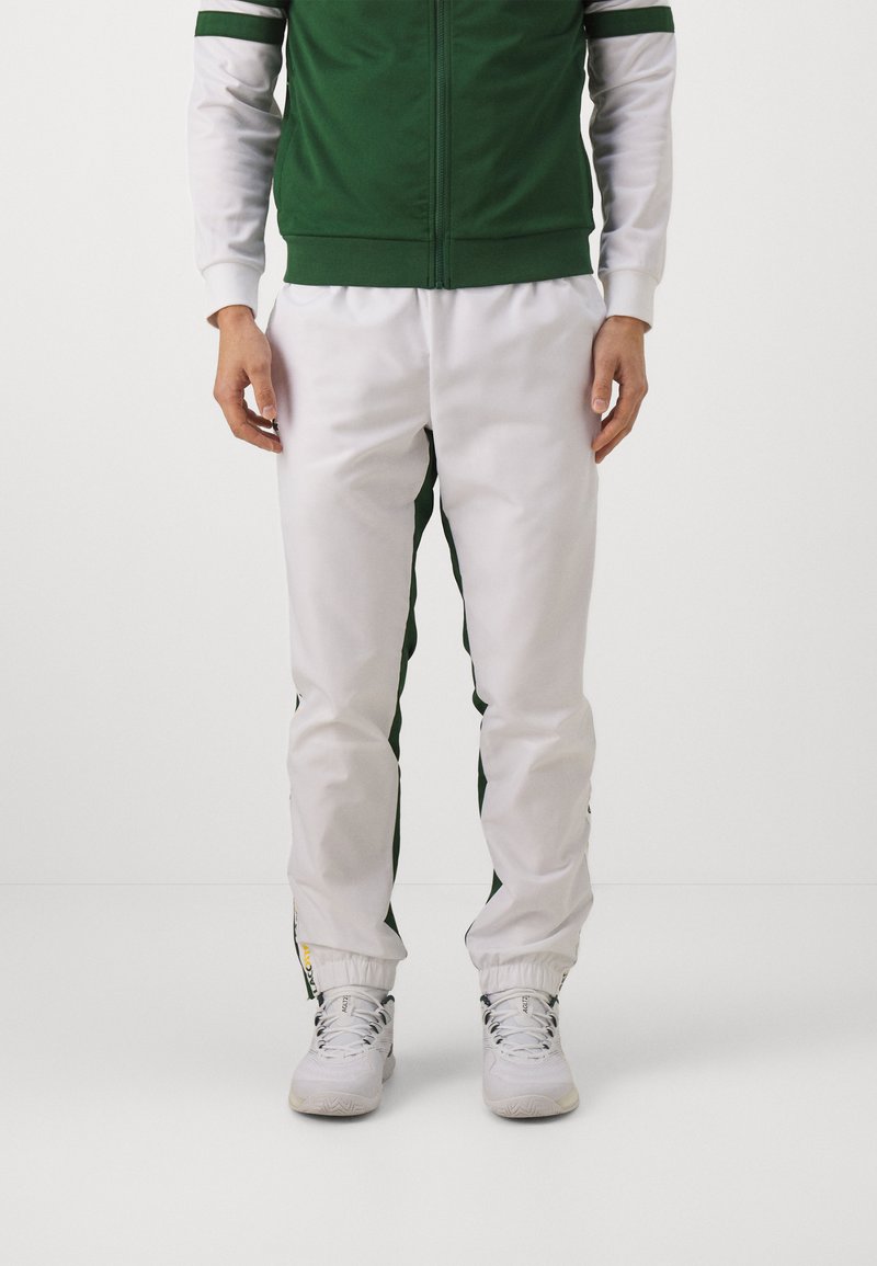 Lacoste Sport TROUSERS TC - Tracksuit bottoms - white/green/white ...