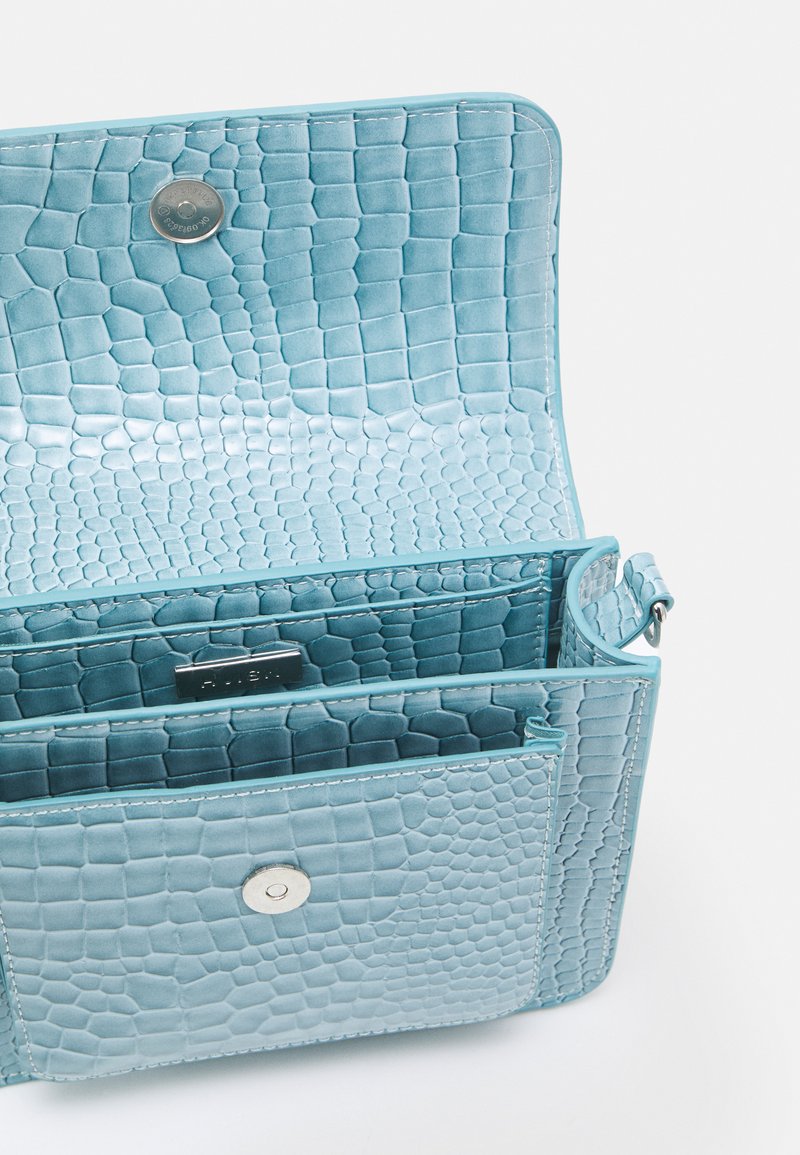 Turquoise Crocs Cayman