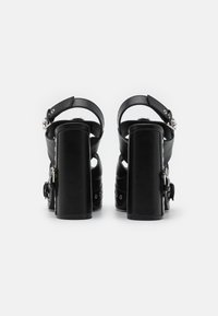 Koi Footwear ROTTEN MINDS BUCKLE PLATFORM - Platform sandals - black ...