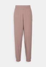 Puma STUDIO UNWIND JOGGER - Tracksuit bottoms - dark clove/pink ...