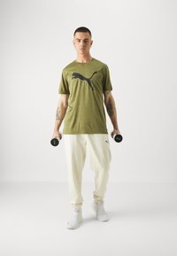 Puma TRAIN CAT TEE - Sport T-Shirt - olive green heather/oliv - Zalando