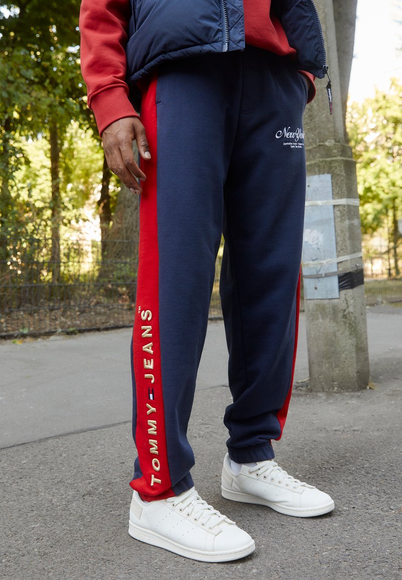 Tommy Jeans ARCHIVE - Tracksuit bottoms - twilight navy/multi/dark blue ...