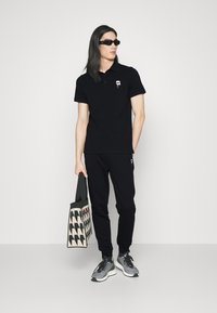 KARL LAGERFELD PANTS - Tracksuit bottoms - black/black - Zalando.ie
