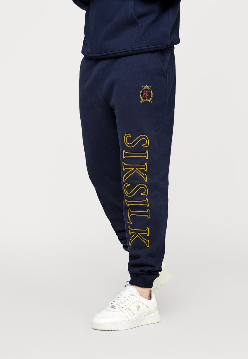 Siksilk Crest Embroidery Relaxed Fit Tracksuit Bottoms Navy Dark