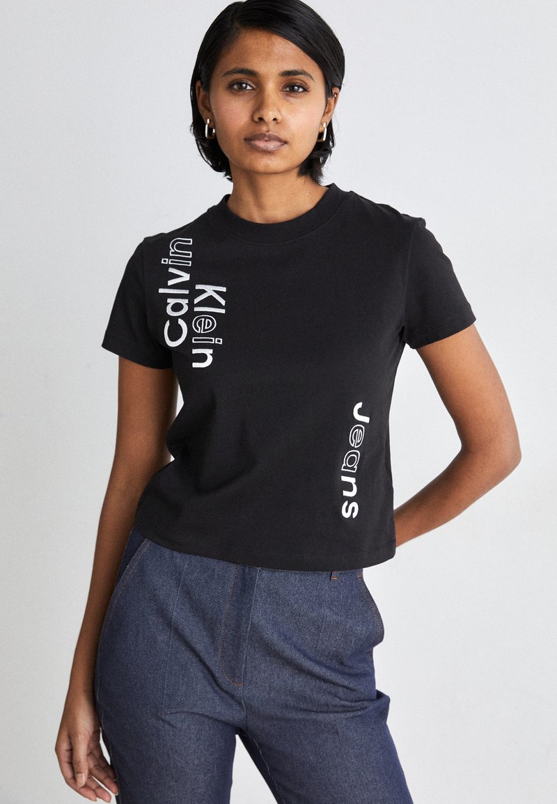 Calvin Klein Jeans MULTI PLACEMENT LOGO TEE - Print T-shirt - black ...
