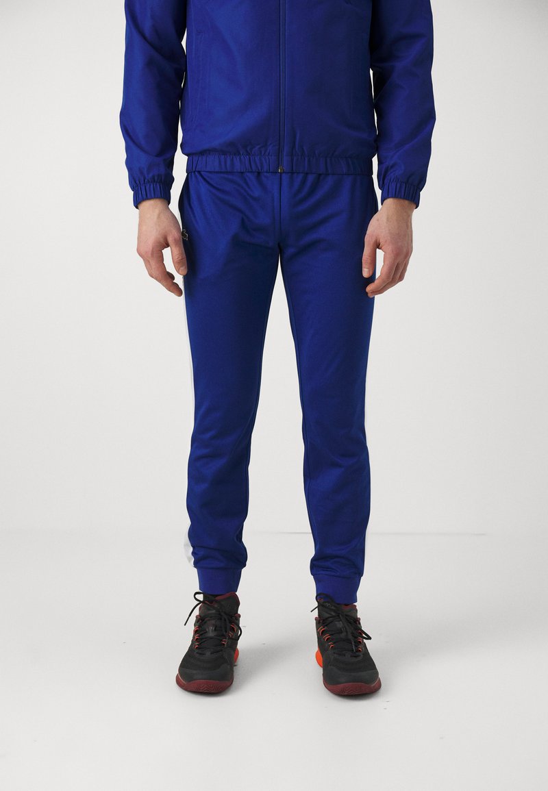 Lacoste Sport TROUSERS TC - Tracksuit bottoms - captain/white/blue ...